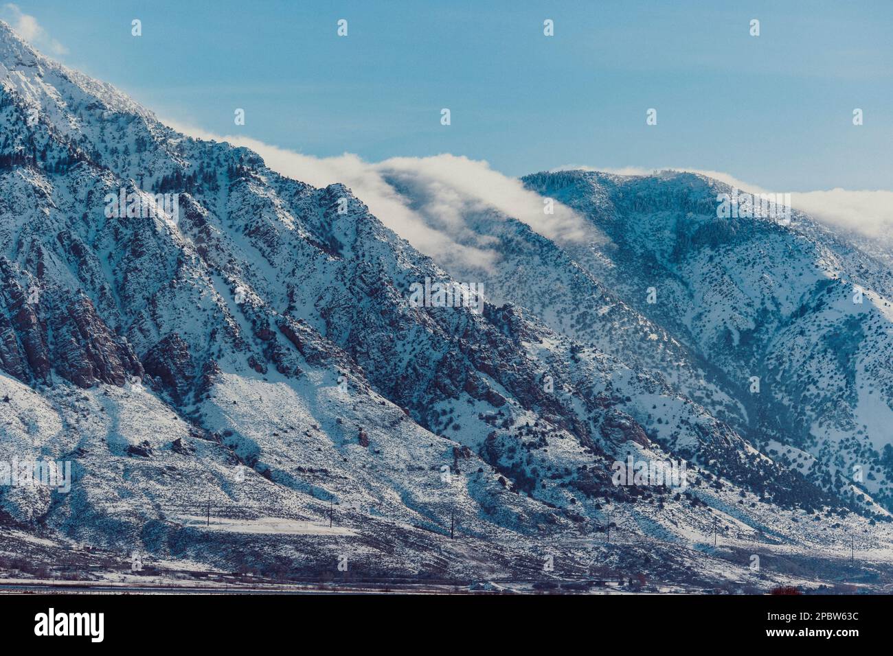 Rugged Utah mountains reflect in the bright snow Stock Photo - Alamy