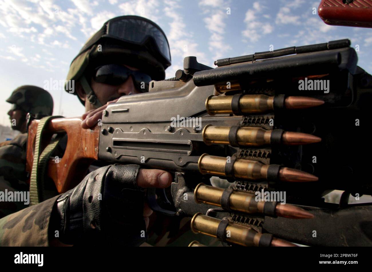 An Iraqi army soldier mans a machine gun on a security checkpoint in ...