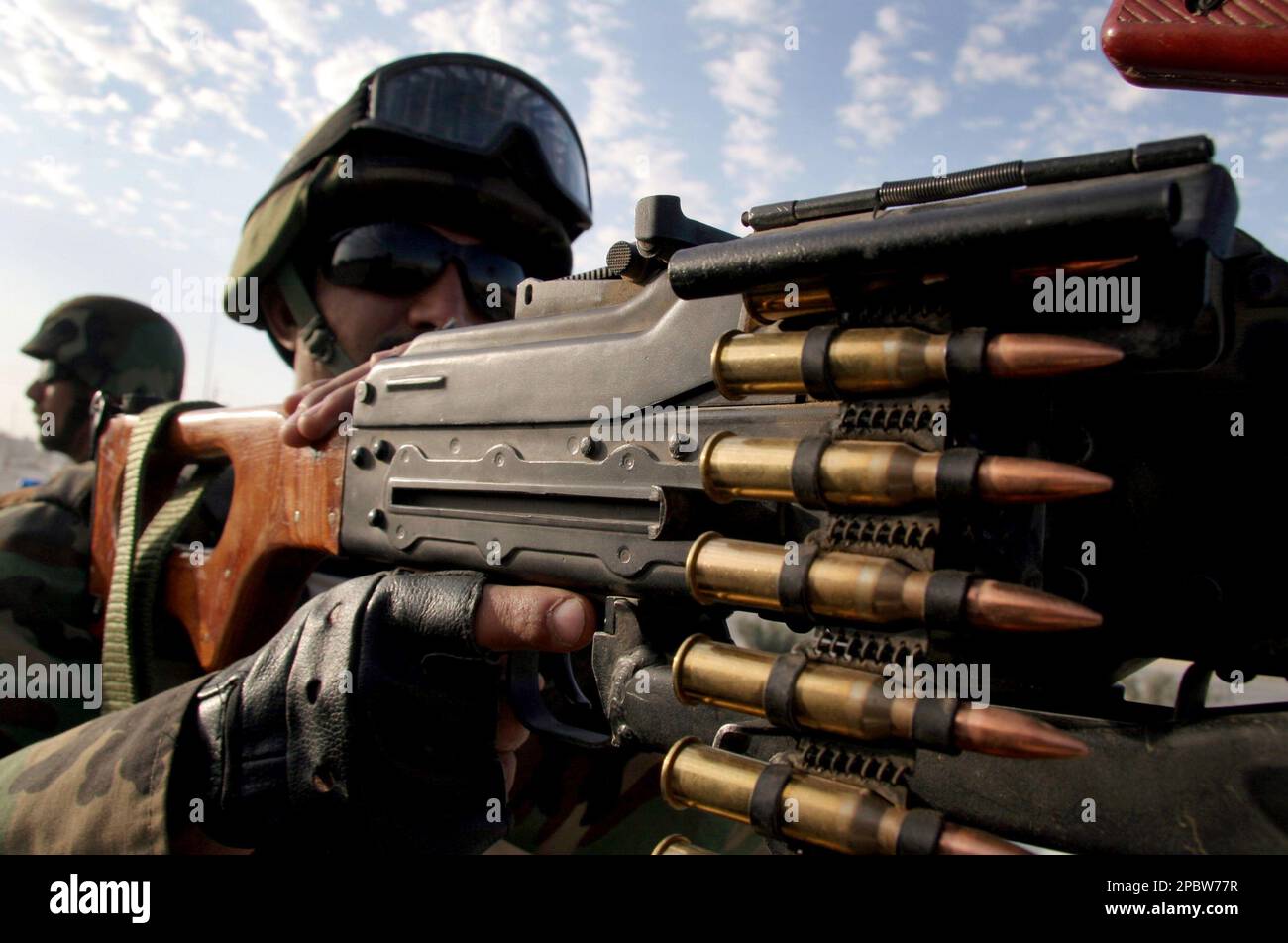 An Iraqi army soldier mans a machine gun on a security checkpoint in ...