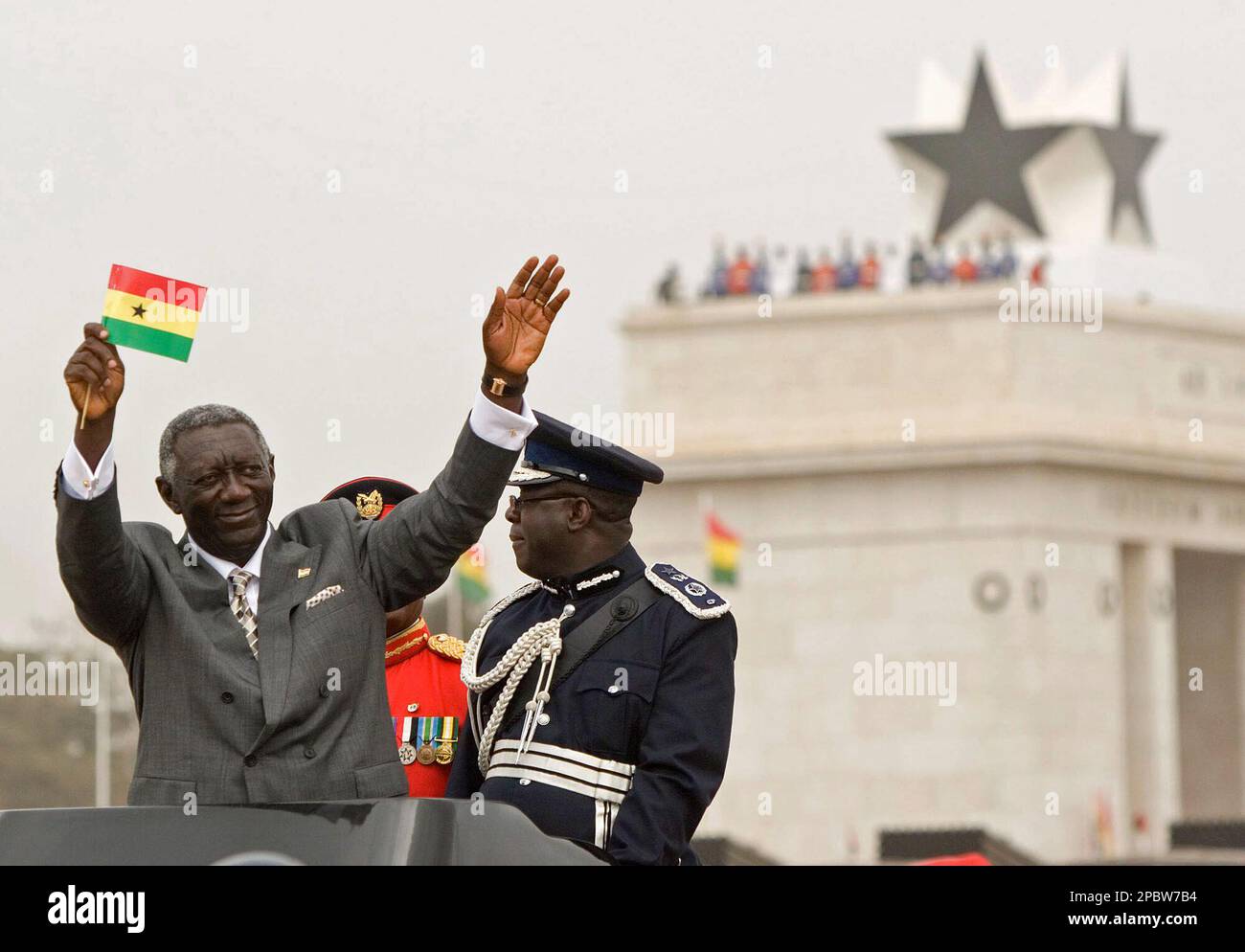 Ghanaian President John Kufuor waves during a celebration to mark Ghana ...