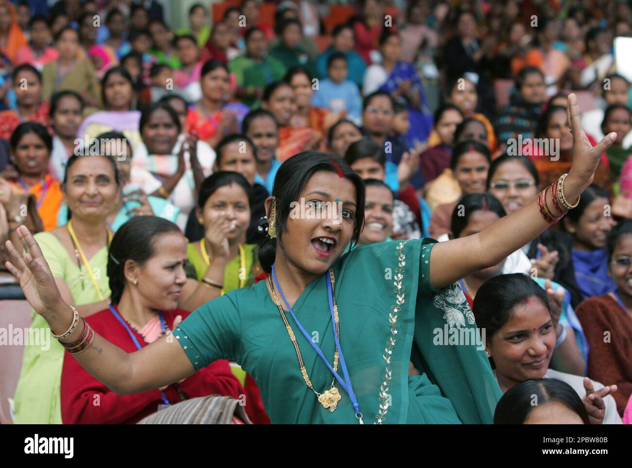 A woman dances as she watches a function to celebrate women empowerment ...