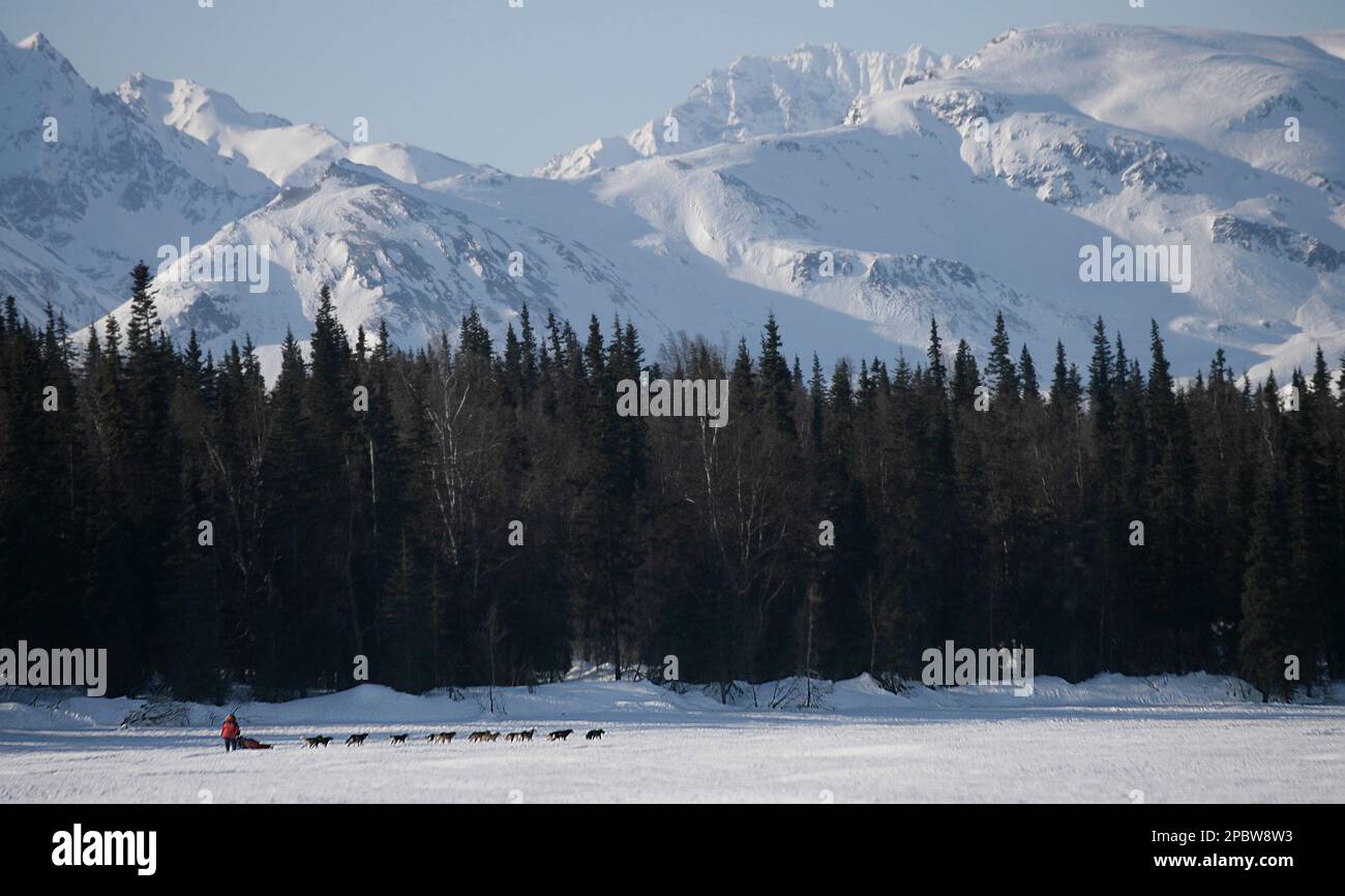 Randy Cummins drives his dog team along Finger Lake with the Alaska ...