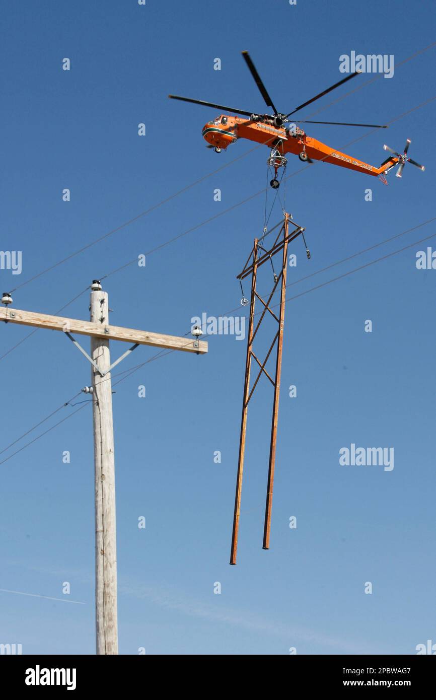 A Sikorsky S-64 helicopter nicknamed "Olga" moves an H-frame structure ...