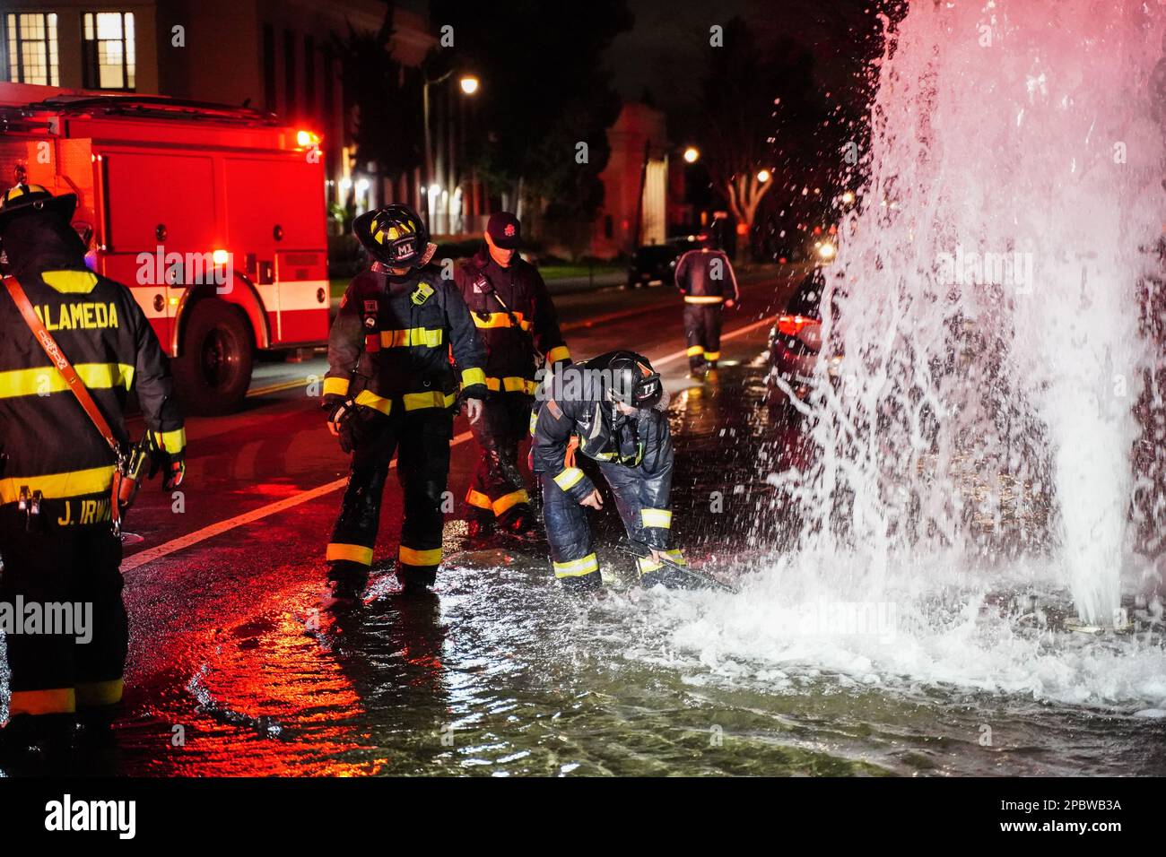Firefighters work on the fire hydrant. A fire hydrant located at the ...