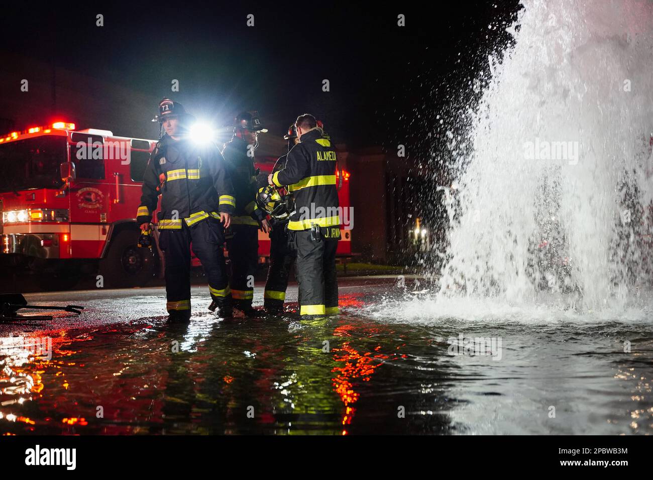 Firefighters discuss the solution on how to stop water. A fire hydrant ...