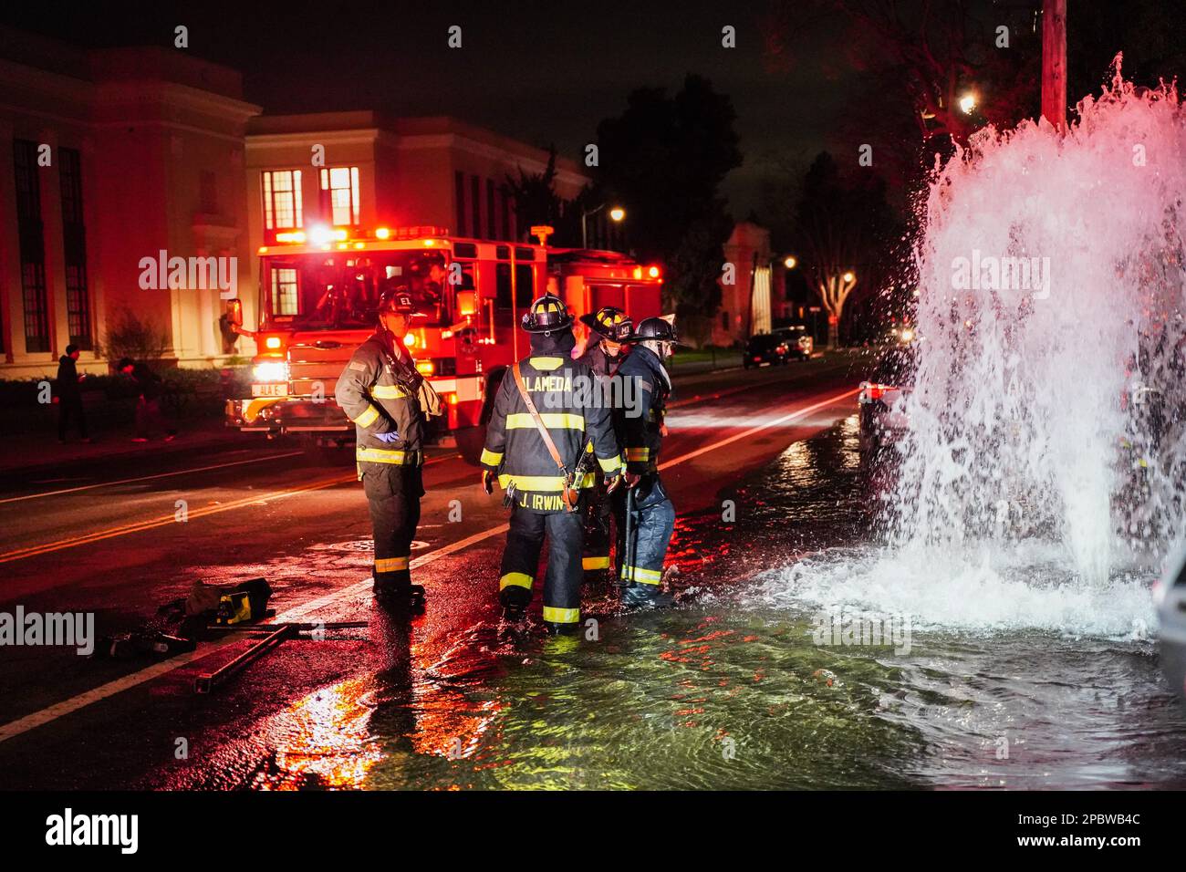 Firefighters work on the fire hydrant. A fire hydrant located at the ...