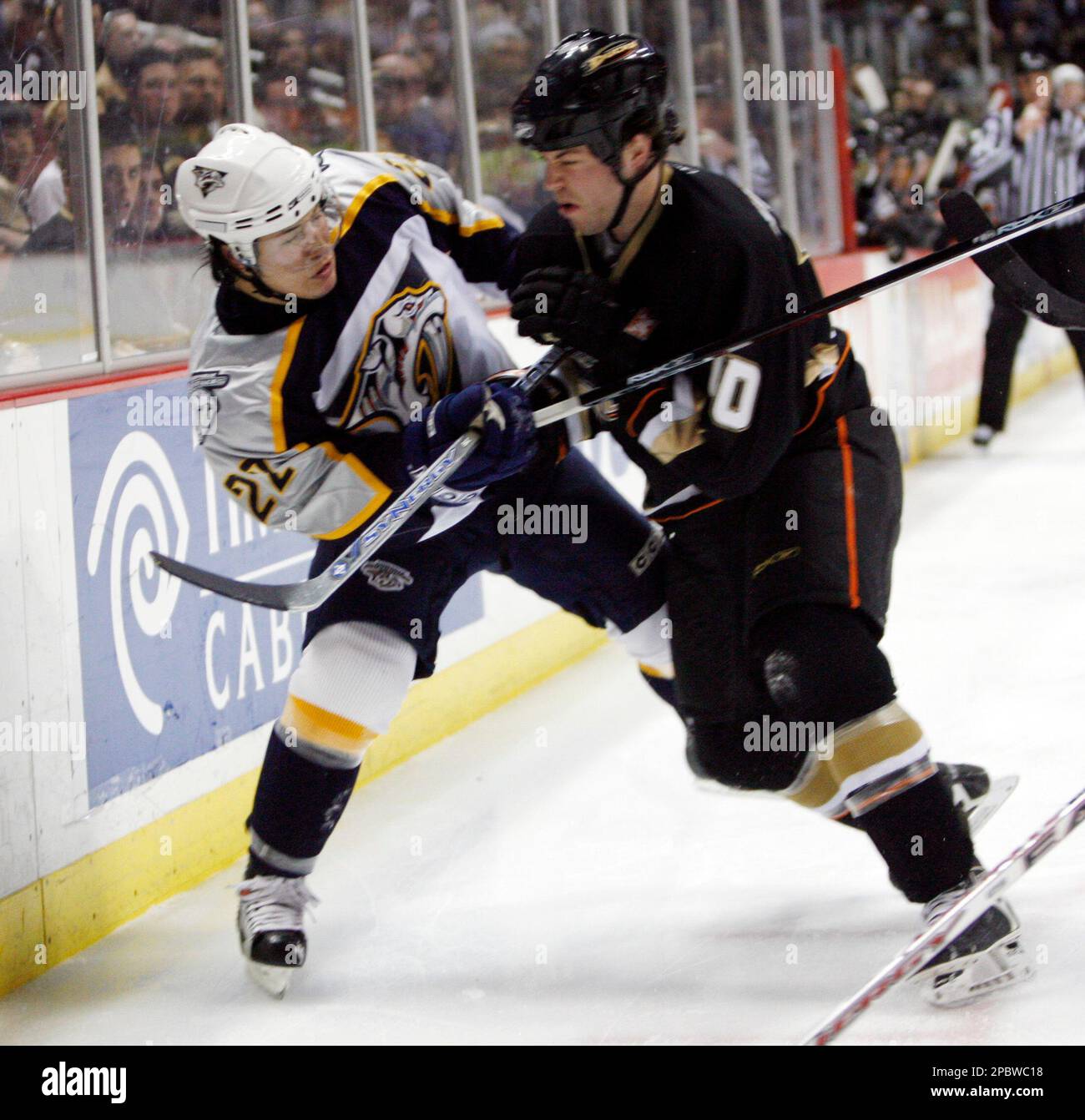 Anaheim Ducks defenseman Kent Huskins, right, hits Nashville Predators ...