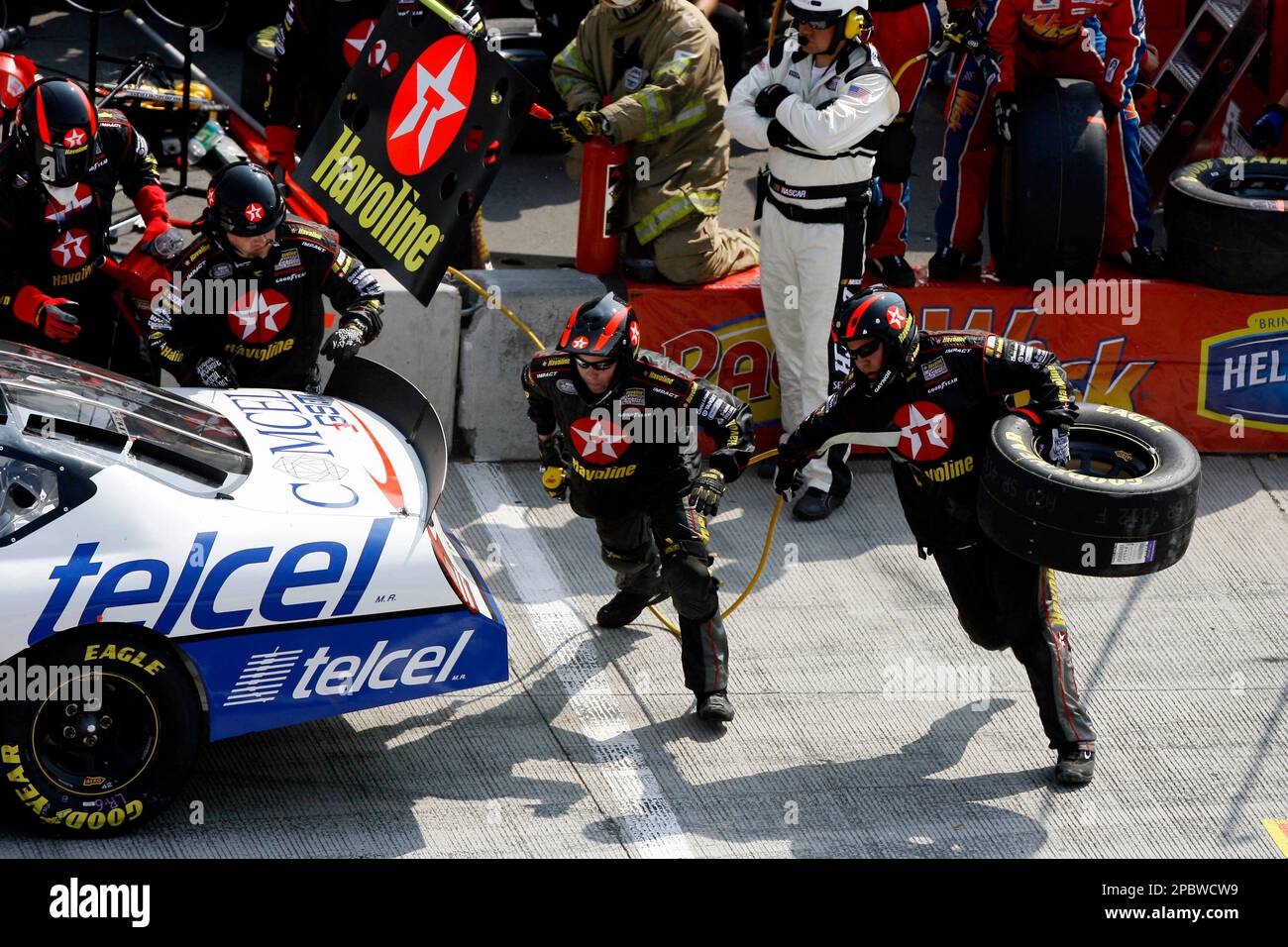 Technicians work on a Dodge driven by Juan Pablo Montoya from Colombia ...