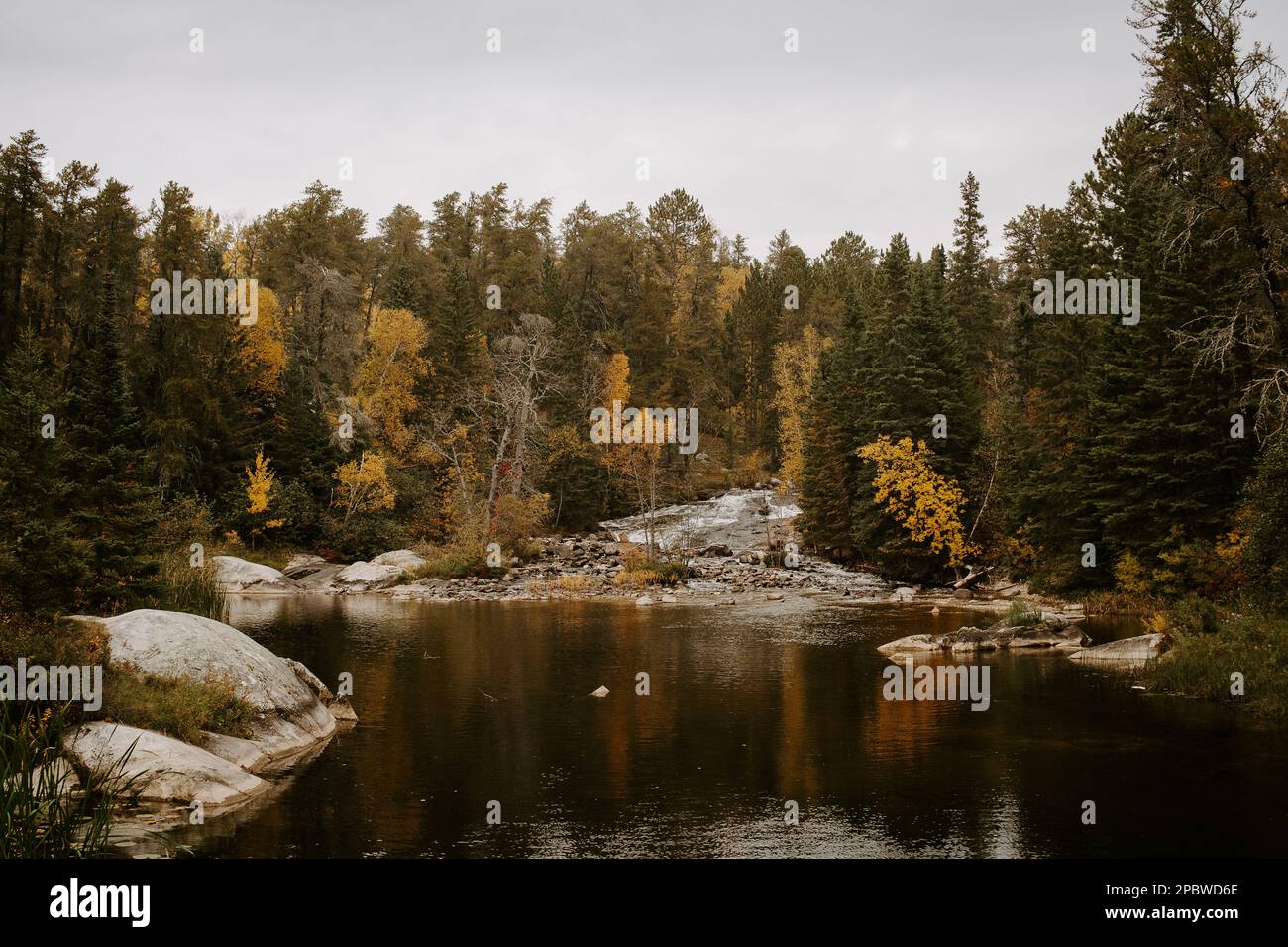 Calm lake on a cloudy fall day in Rushing River, Ontario Stock Photo ...