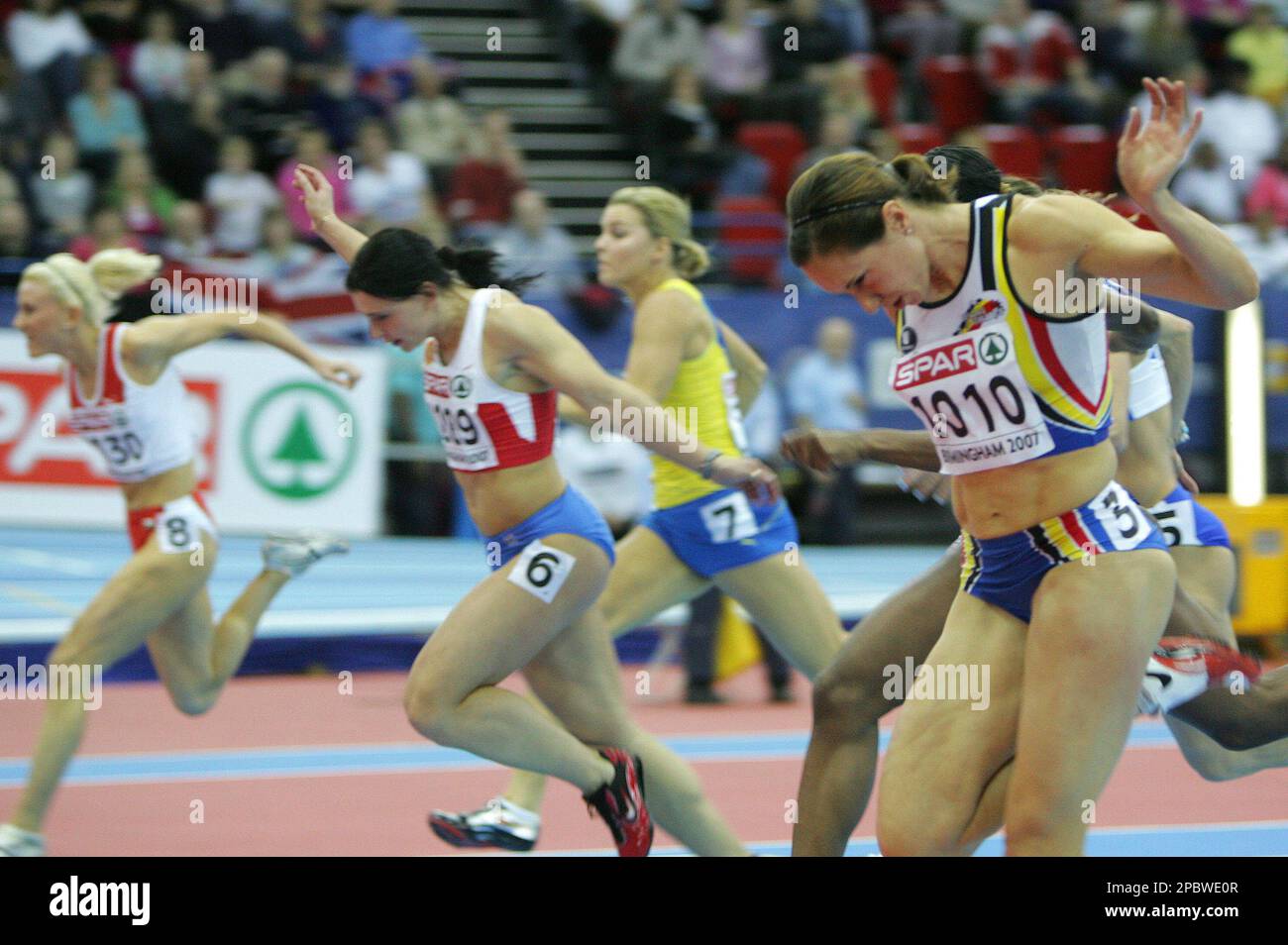 Belgium's Kim Gevaert, right, crosses the finish line to win the gold ...