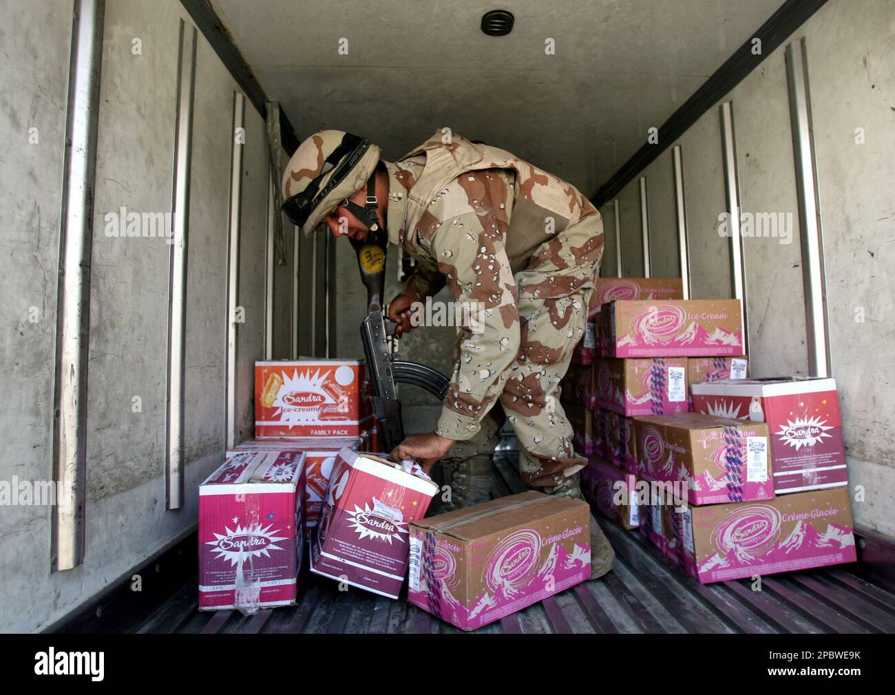 An Iraqi army soldier searches through boxes of ice cream in the back ...