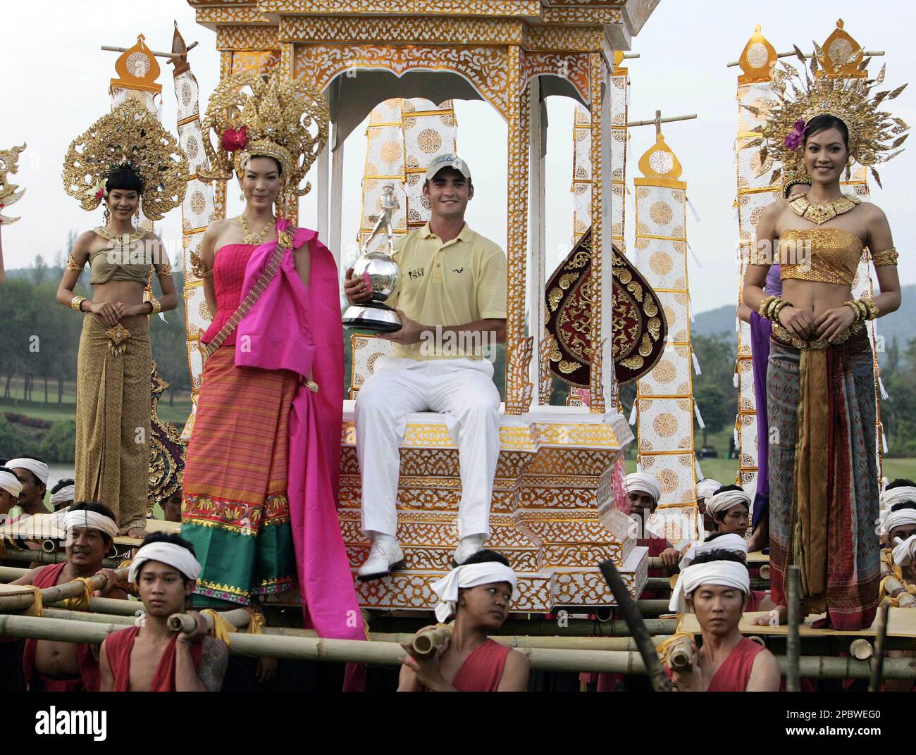 The winner South African Anton Haig holds his winning trophy on Thai ...