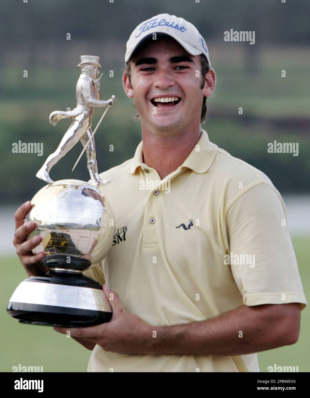 The winner South African Anton Haig holds his winning trophy during ...