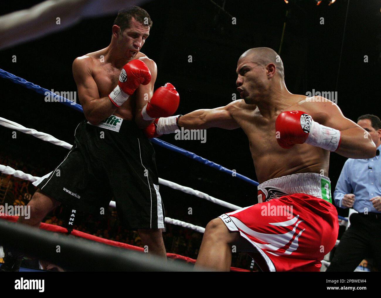 Puerto Rico's Miguel Cotto, right, lands a body punch on challenger ...