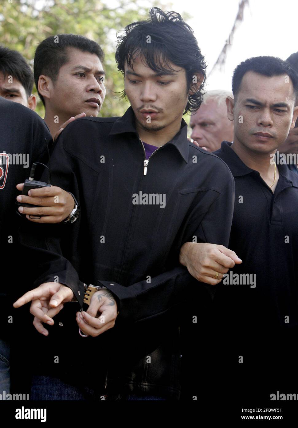 Anuchit Lamlert, 24, center, a Thai man who was arrested for the ...