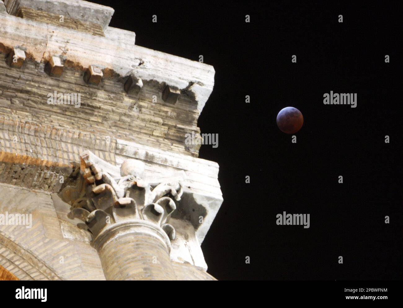 The moon is seen over the top of the Colosseum on the night of a total ...