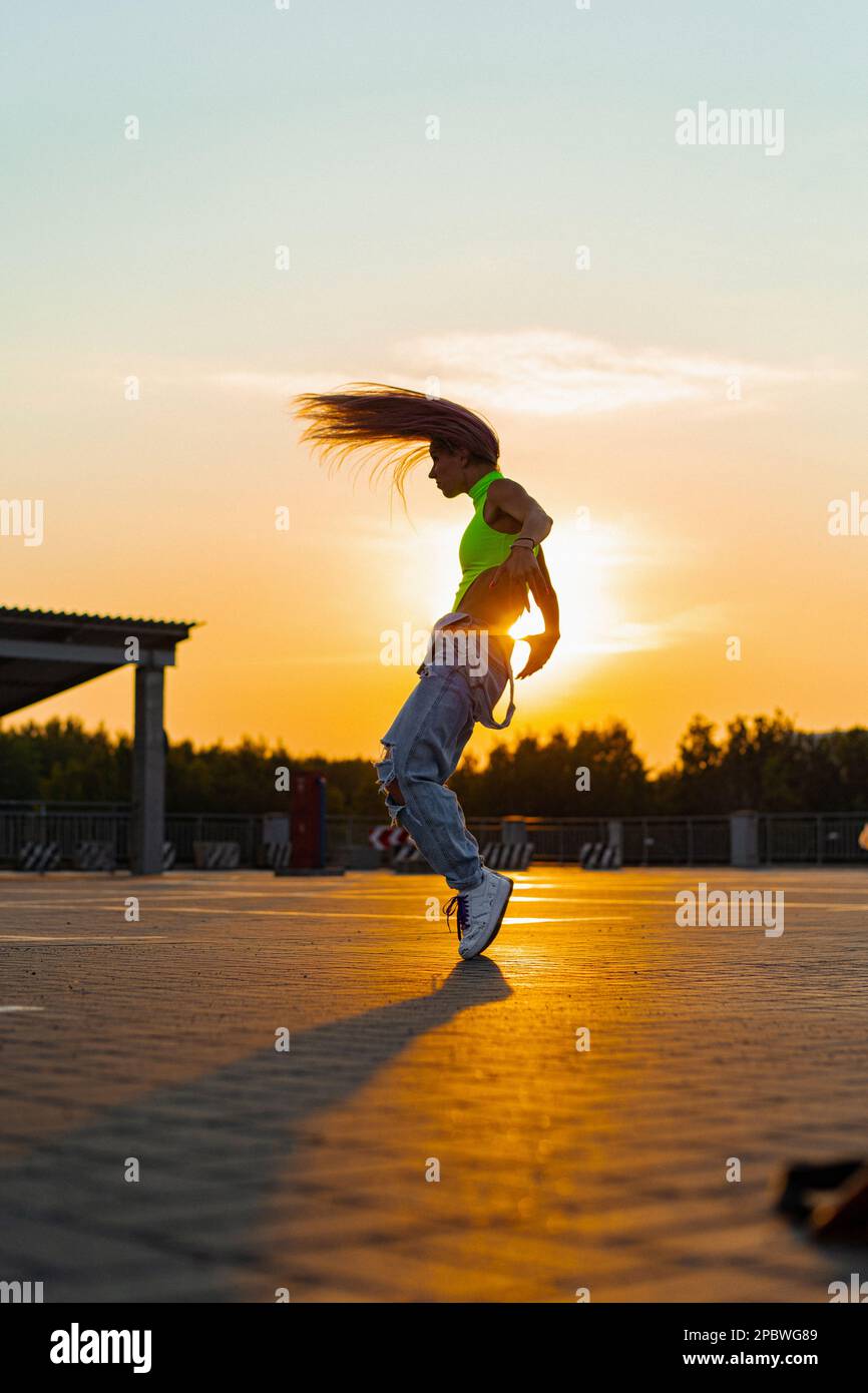 Woman dances at sunset, in motion, flying hair Stock Photo - Alamy Woman dances at sunset, in motion, flying hair Stock Photo - Alamy