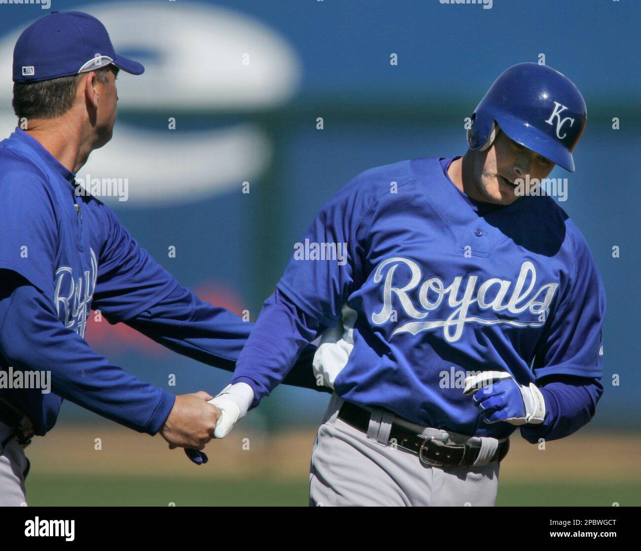 Kansas City Royals' Mark Teahen, right, is congratulated by third base ...