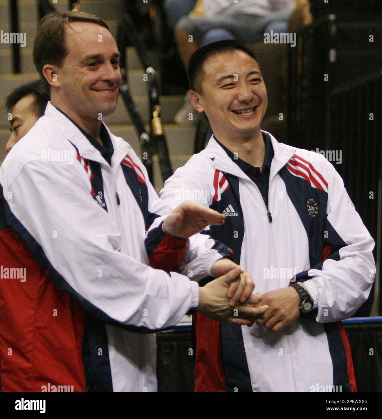 United States gymnastic coaches Dan Baker, left and Liong Chow ...