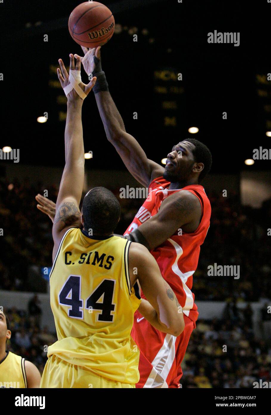 Ohio State guard center Greg Oden,right shoots over the defense of ...