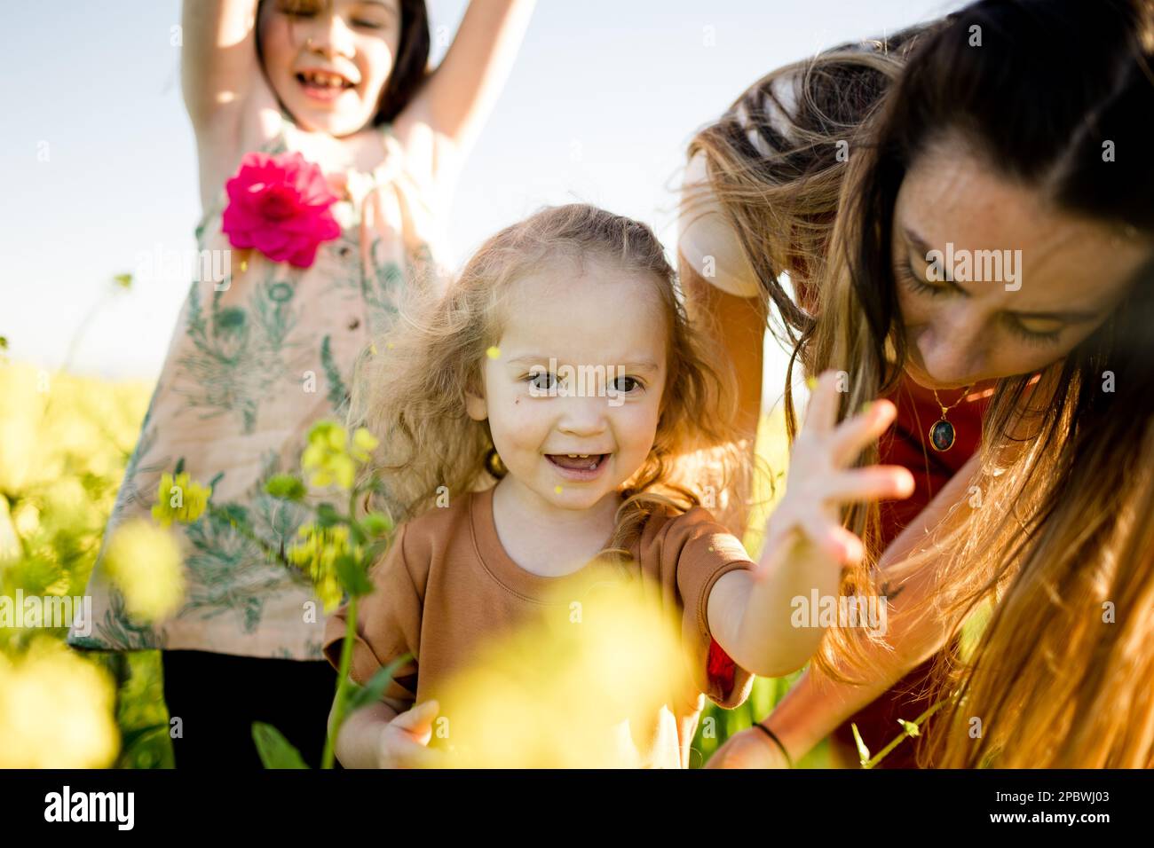 Girls Playing in Flower Field in San Diego Stock Photo - Alamy