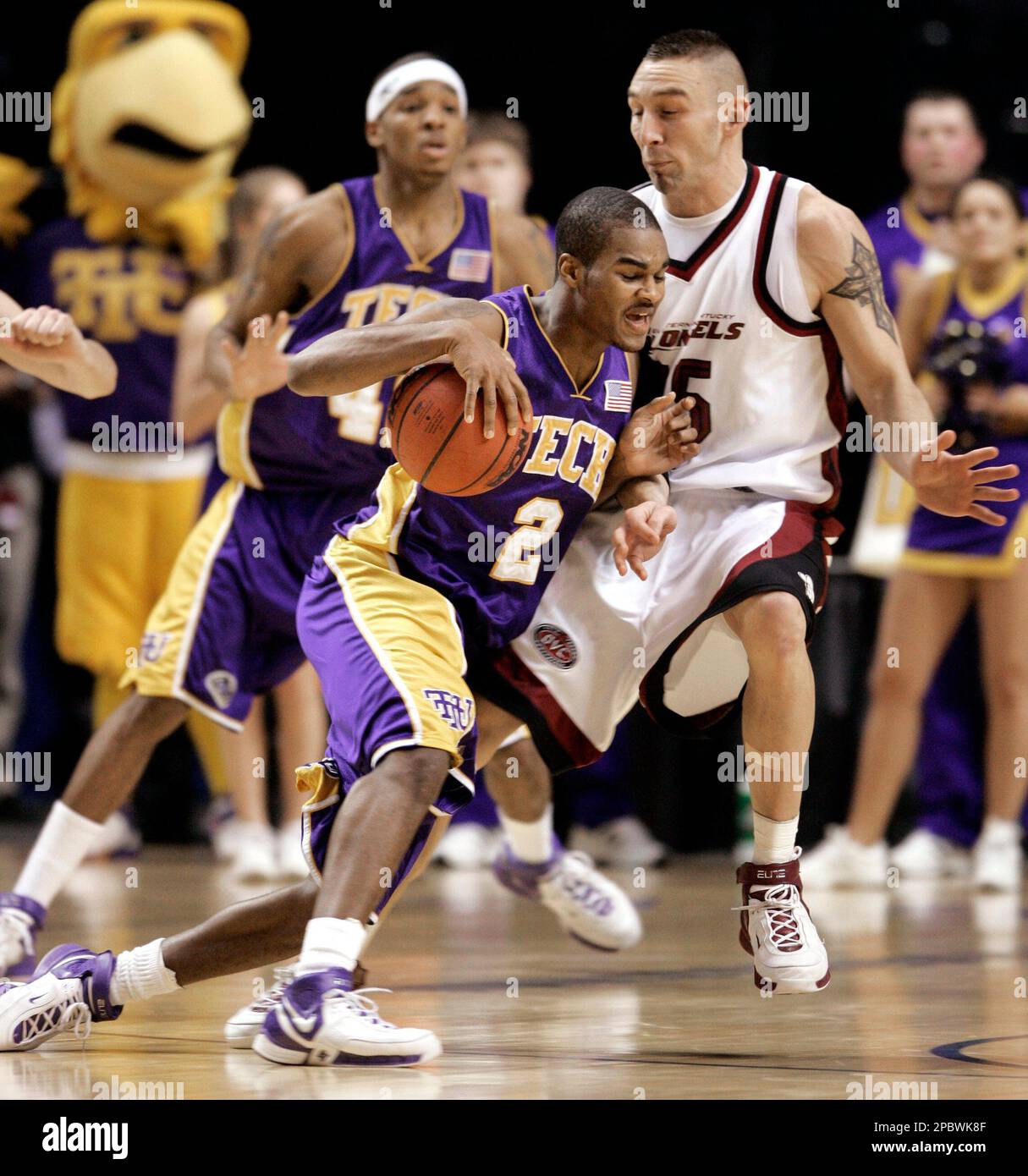 Tennessee Tech guard Anthony Fisher (2) drives into Eastern Kentucky forward Michael Brock ...