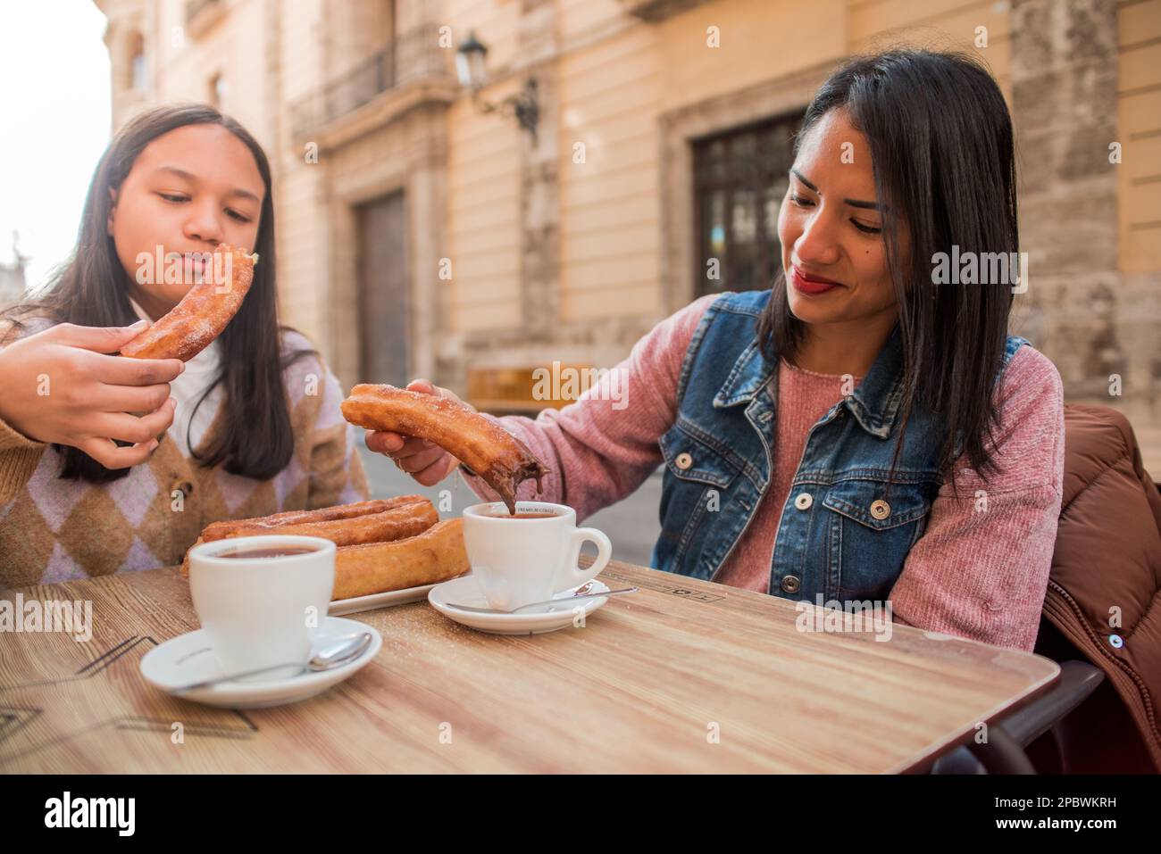 Eating typical spanish churros outdoors in a bar terrace Stock Photo ...