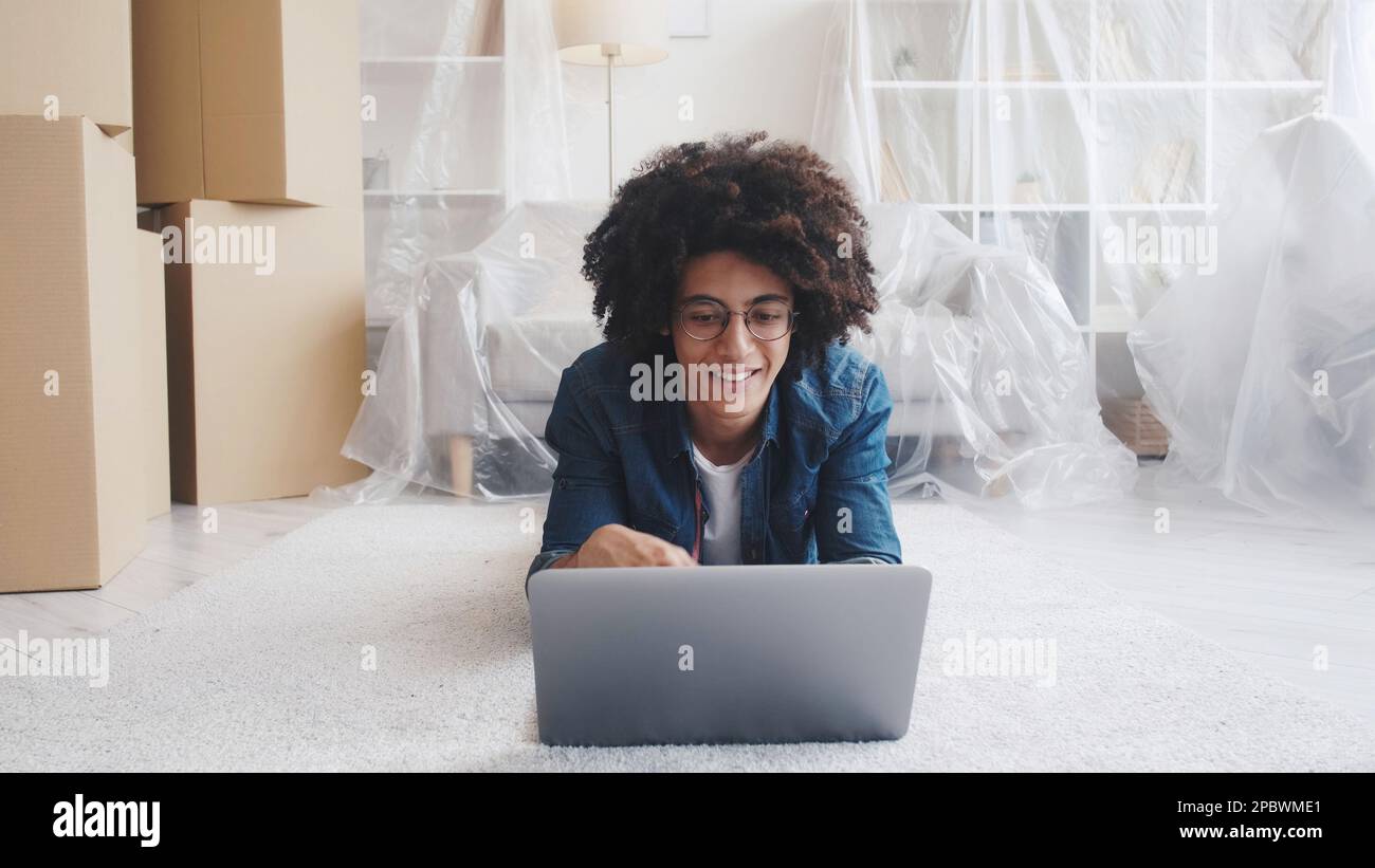 Moving home online relocation man using notebook Stock Photo - Alamy