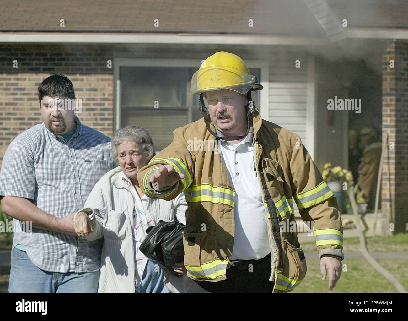 Searcy Fire Marshal Phil Watkins, right, and Edward Moniz Jr. assist ...