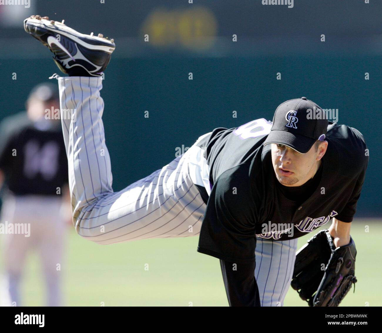 Colorado Rockies starting pitcher Jason Hirsh kicks high as he pitches ...