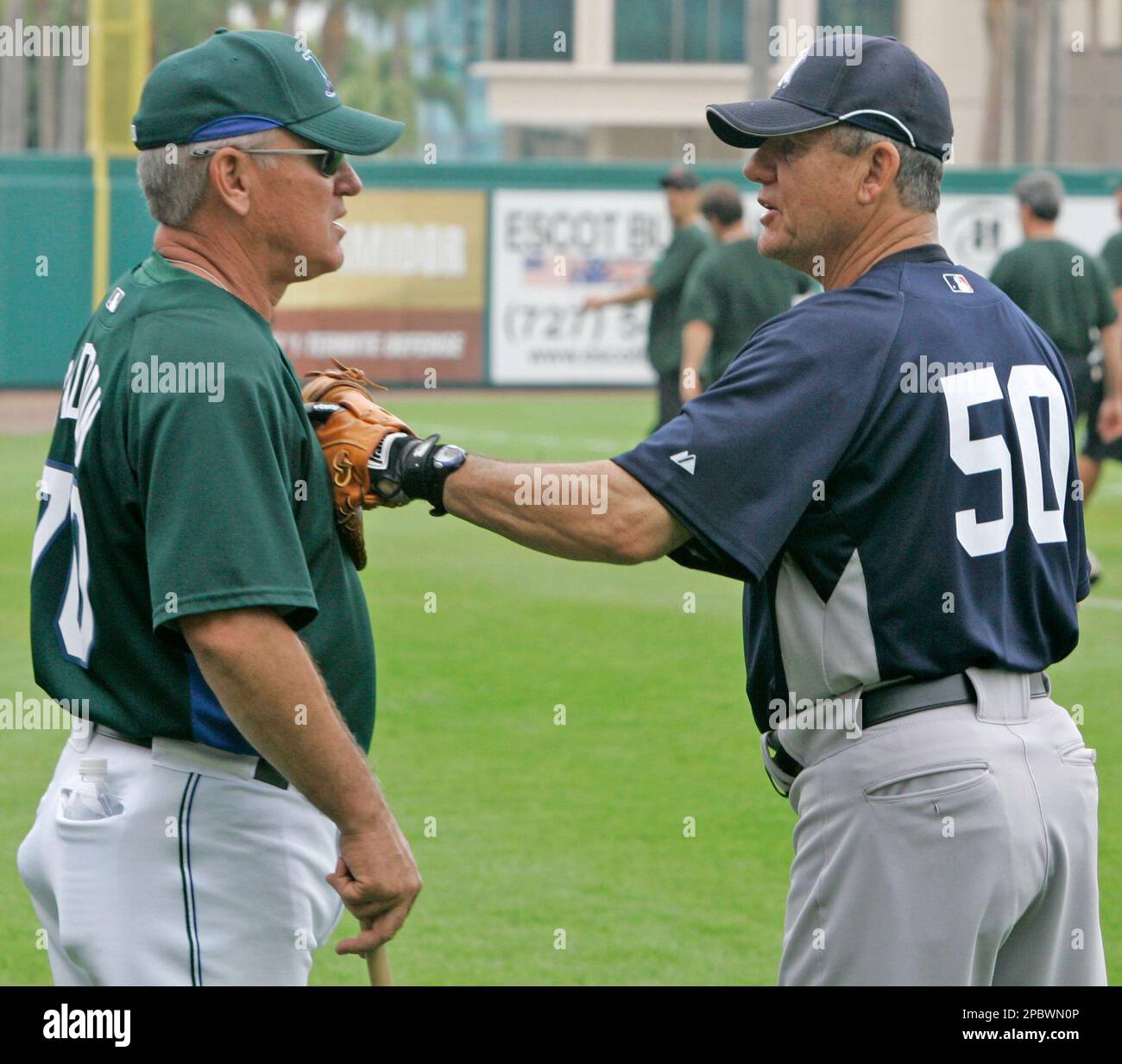 Tampa Bay Devil Rays manager Joe Maddon, left, talks with New York ...
