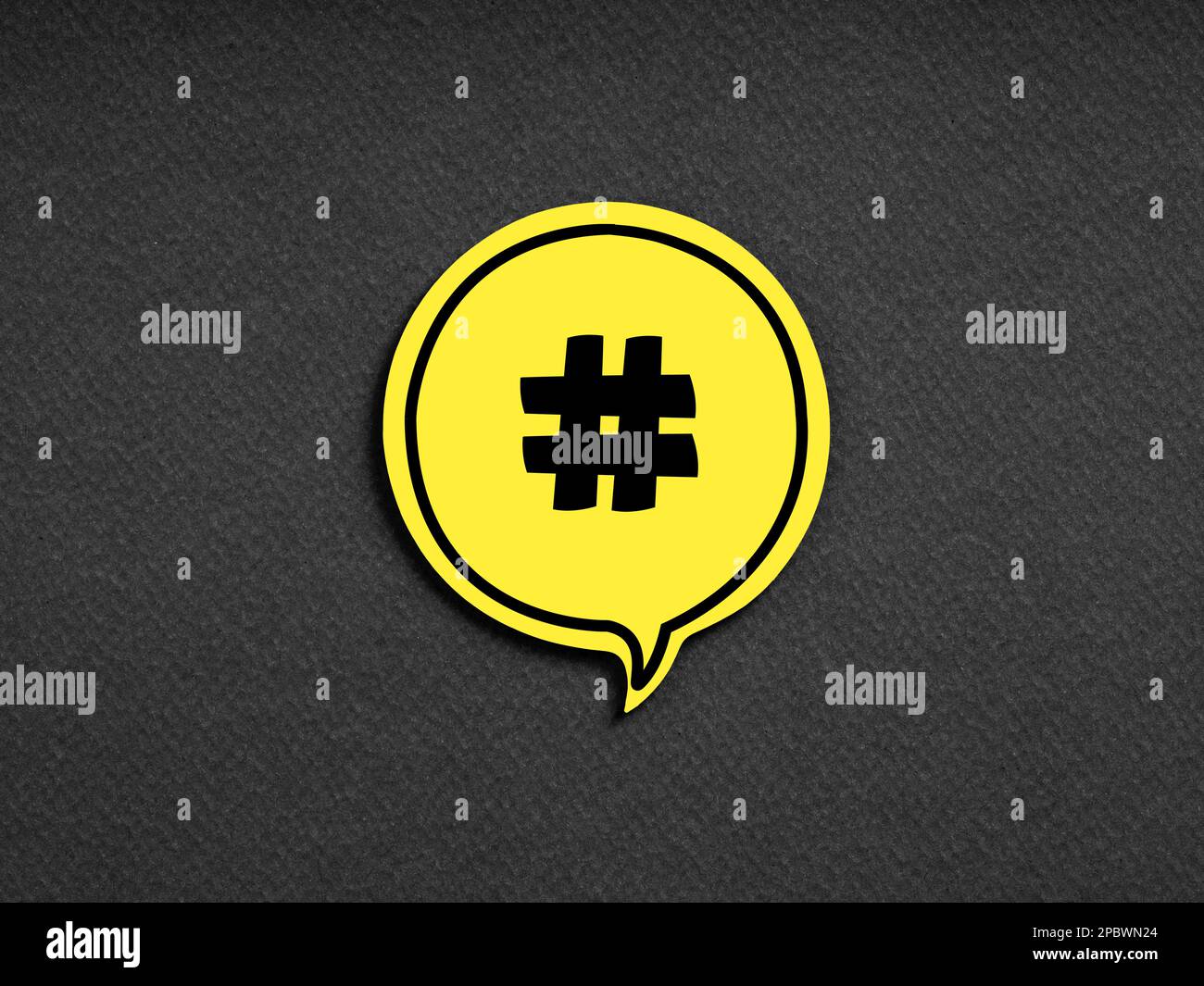 Hashtag symbol on yellow speech bubble on black background. Social ...