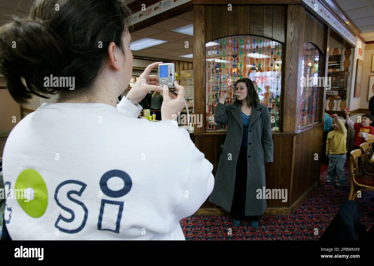 Emily Rhodes, right, poses in front of the beads decoration at the ...