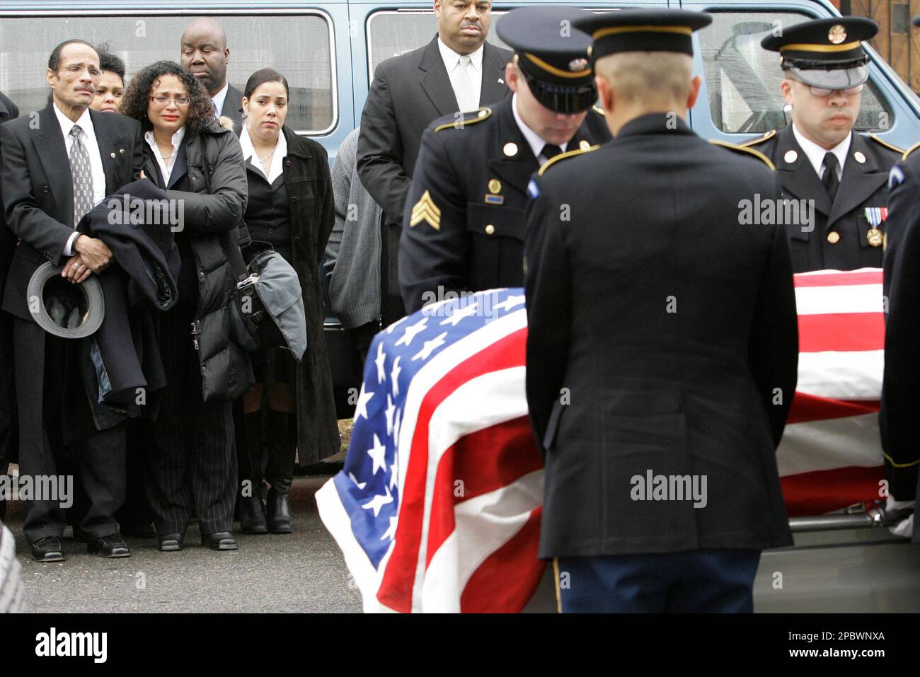 Peter Colon, left, and his sister Norma Colon watch as members of the ...