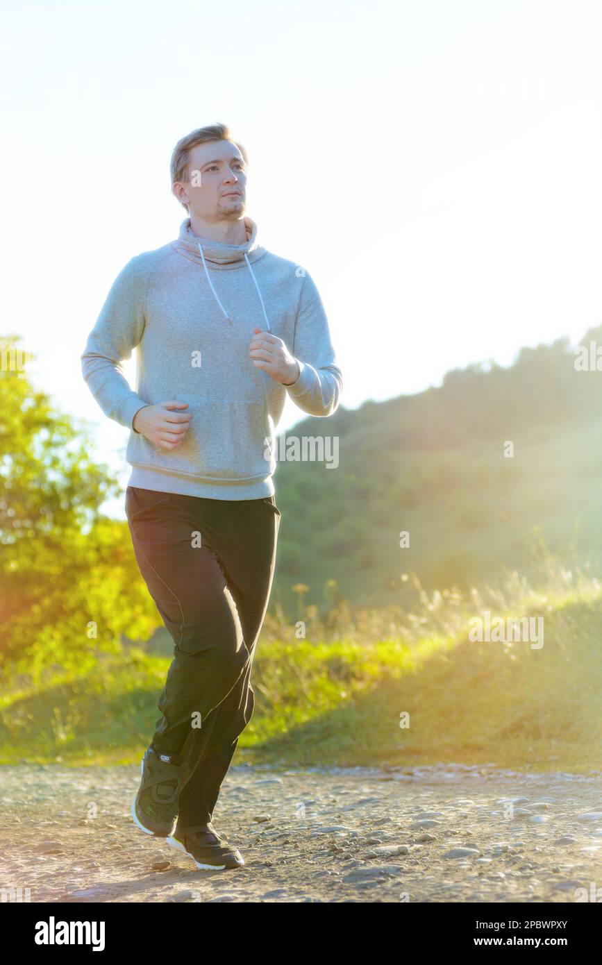Running man jogging in rural nature at beautiful summer day. Sport ...