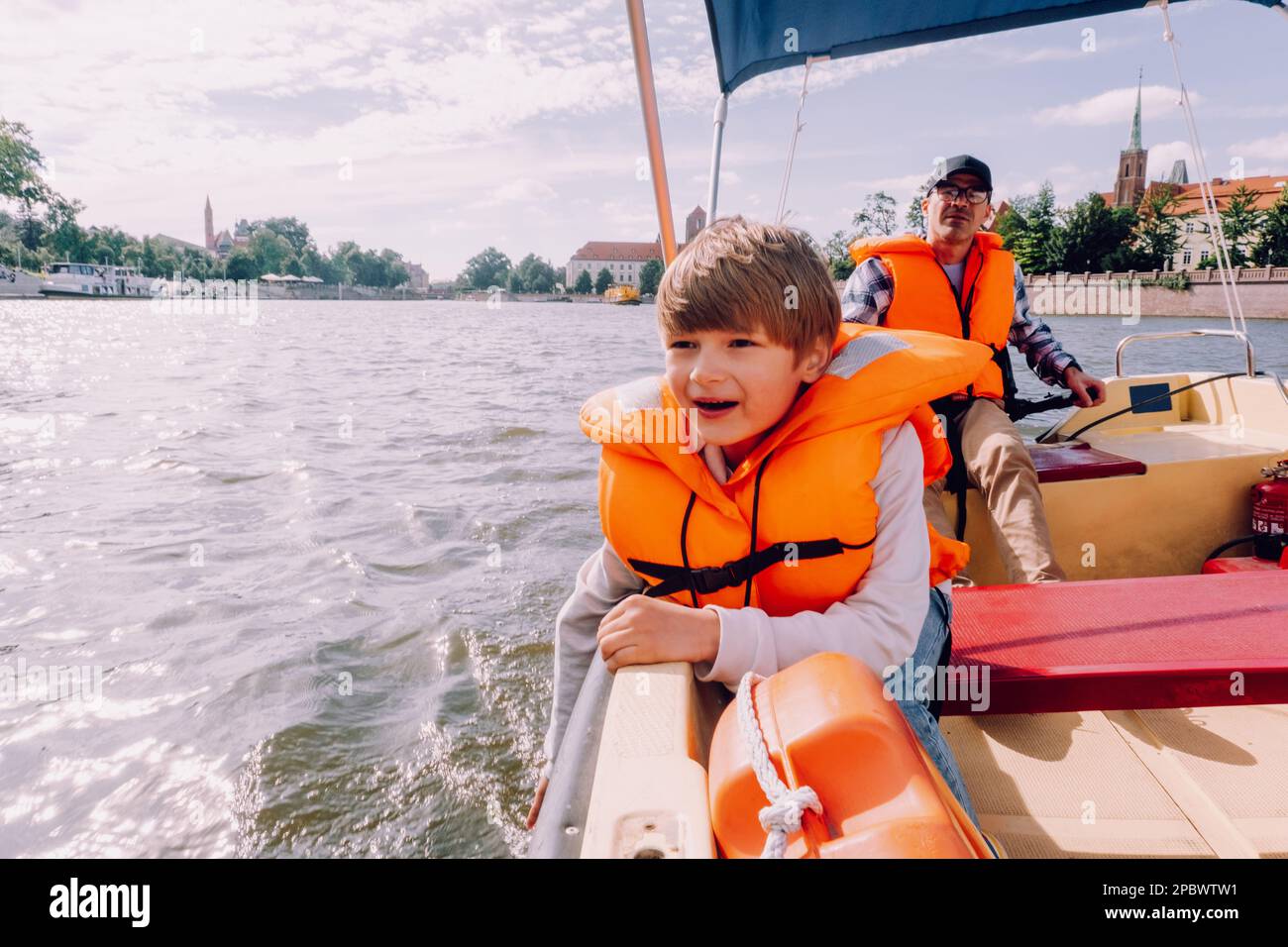 Kid sitting in a boat with father Stock Photo - Alamy