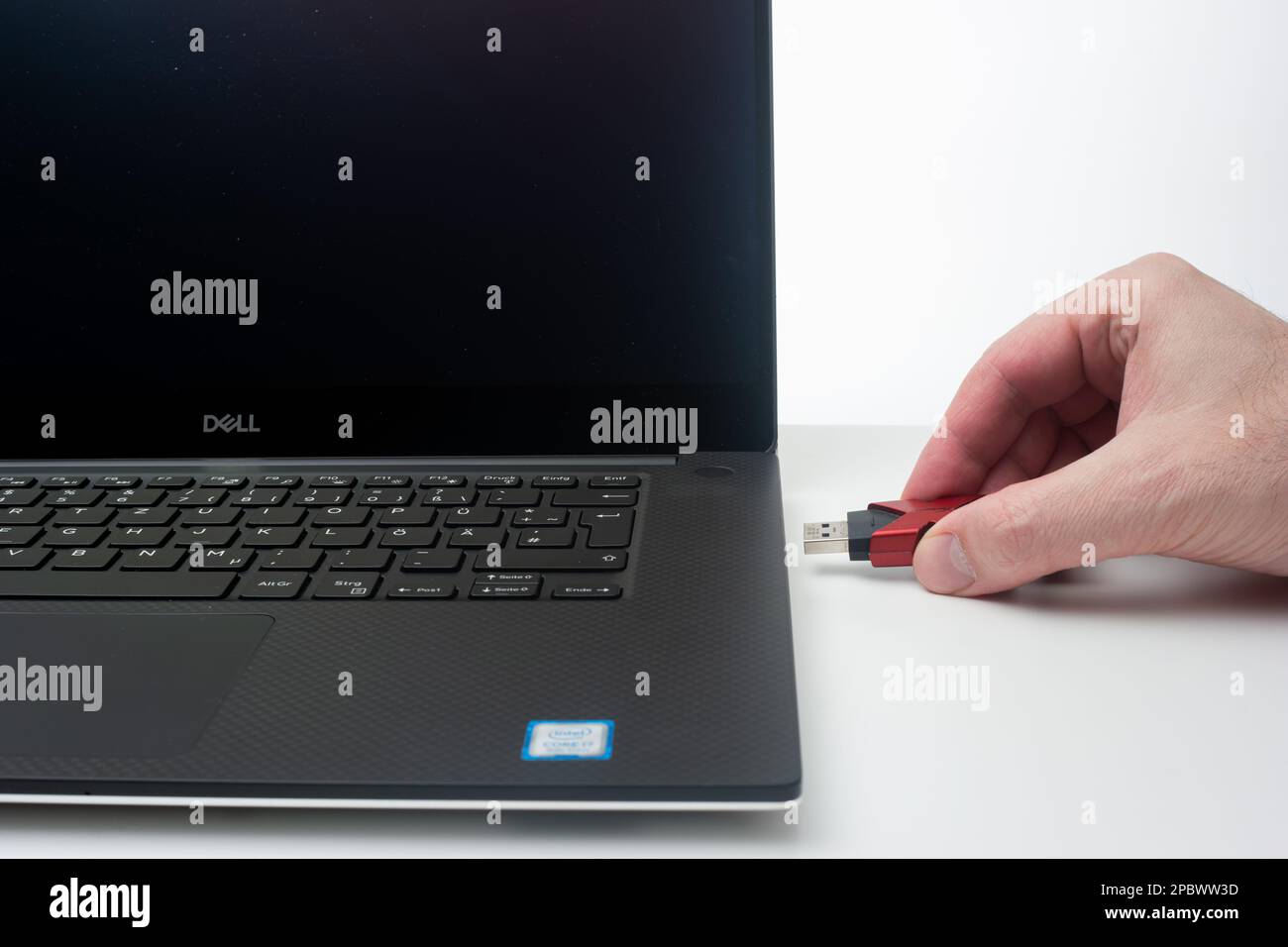 USB memory stick or charger cable being inserted into laptop port by ...