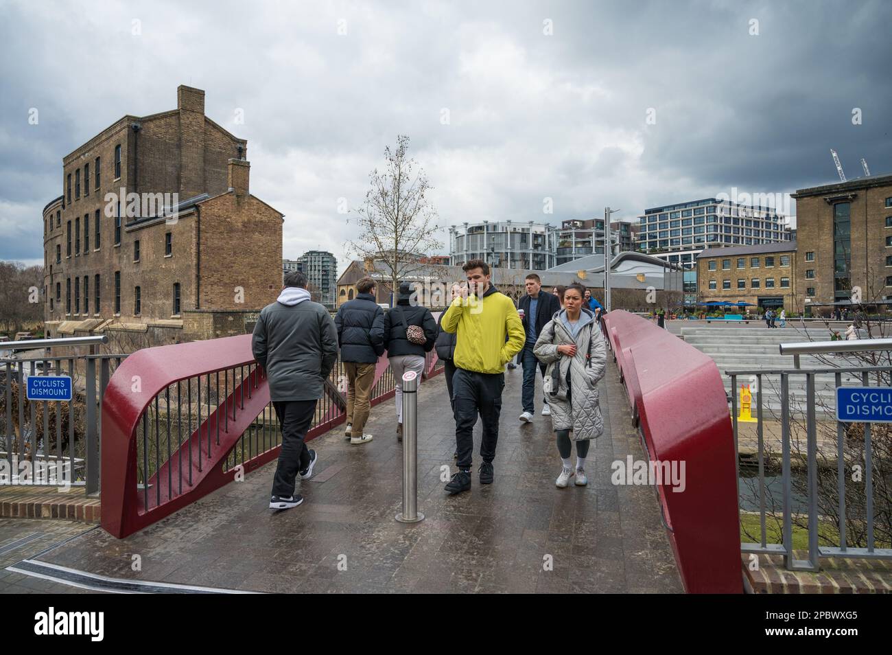 People crossing Esperance Bridge over the Regents Canal, Granary Square ...