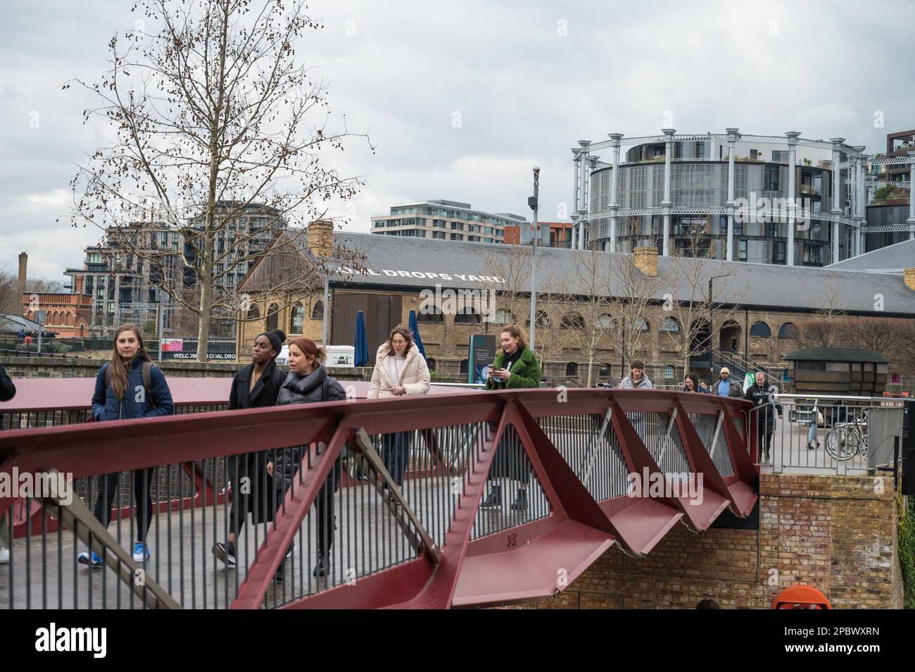 People crossing Esperance Bridge over the Regents Canal, Granary Square ...