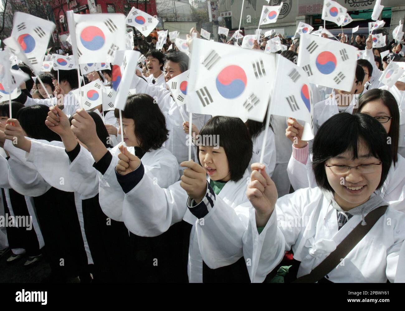 South Korean students wearing traditional Korean costumes wave the ...