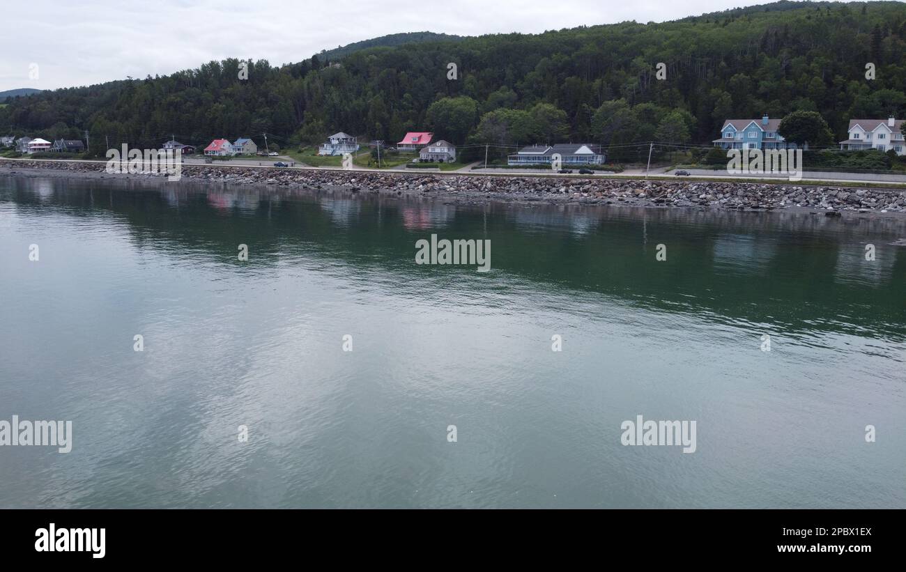 A peaceful landscape featuring a tranquil body of water and distant ...