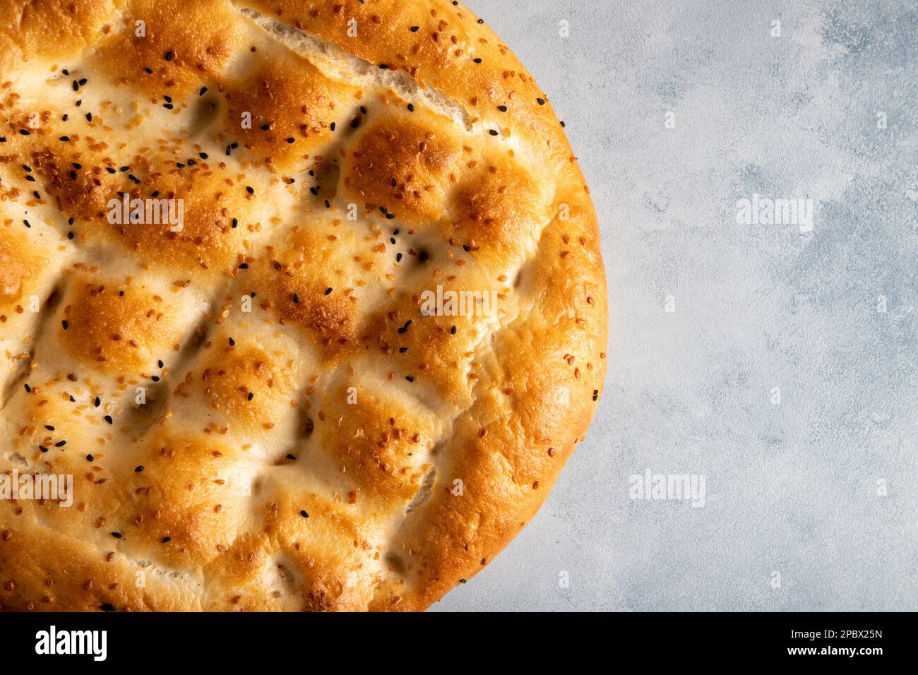 Traditional Ramadan pita on bright blue background.Holy bread for ...
