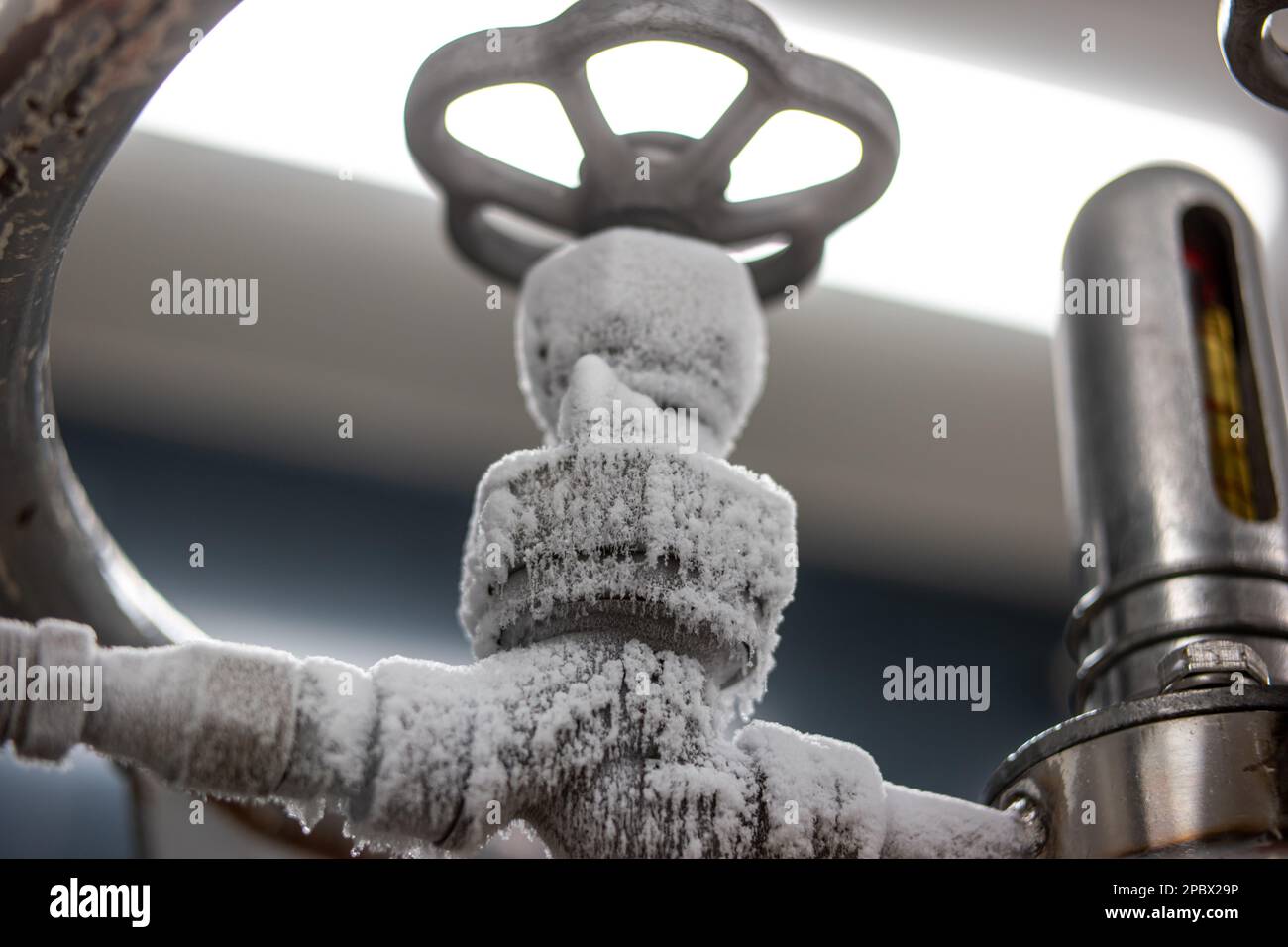 Frozen liquid nitrogen storage tank transfer valve. Close up shot, no ...