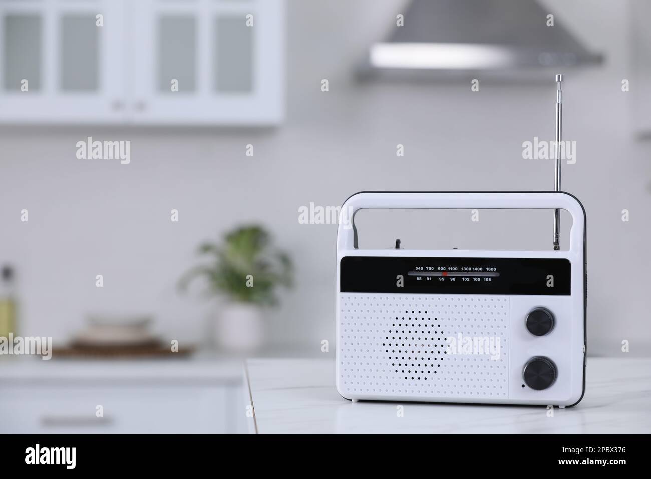 Stylish radio on white marble table in kitchen. Space for text Stock ...