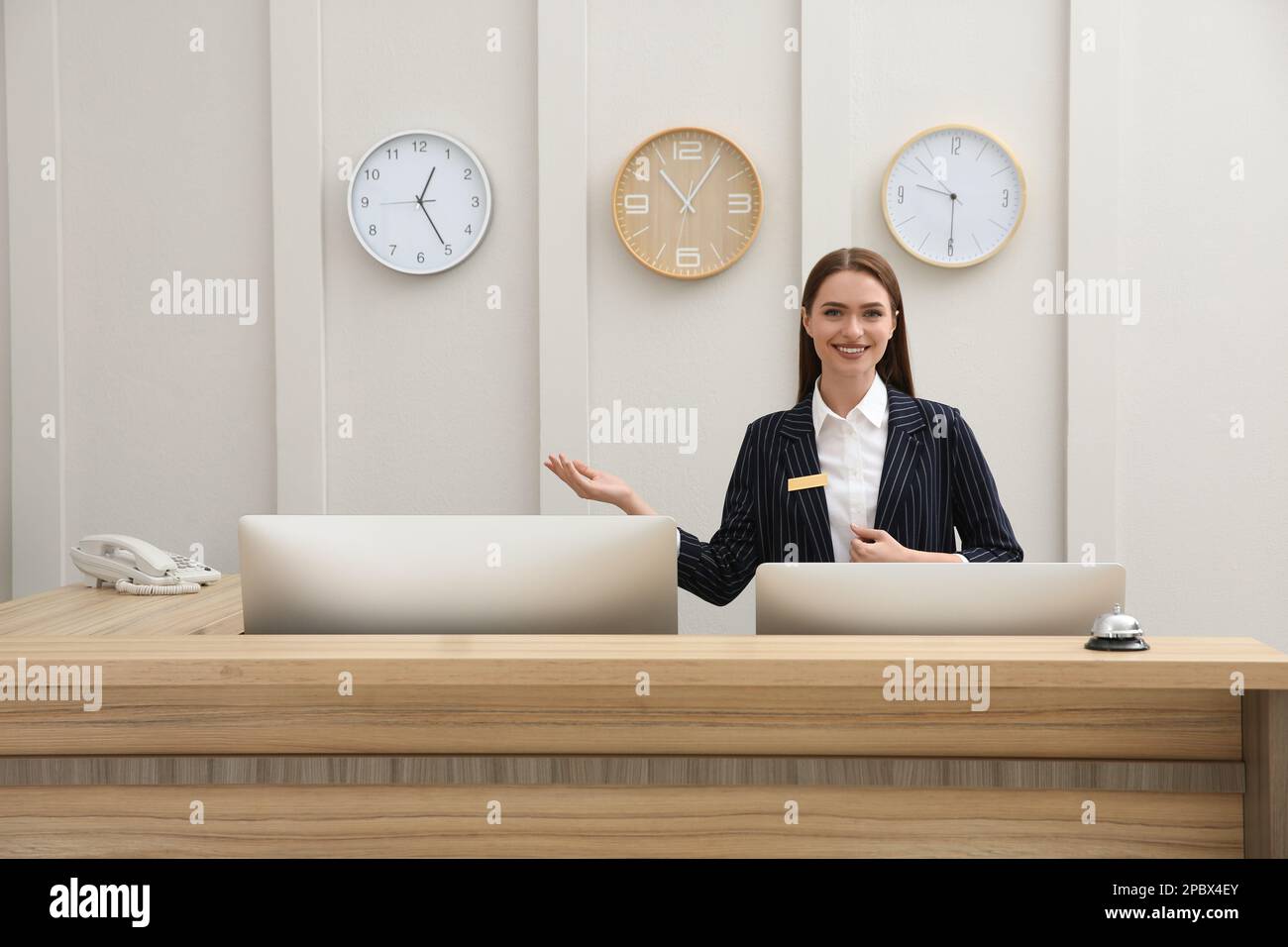 Portrait of beautiful receptionist at counter in hotel Stock Photo - Alamy