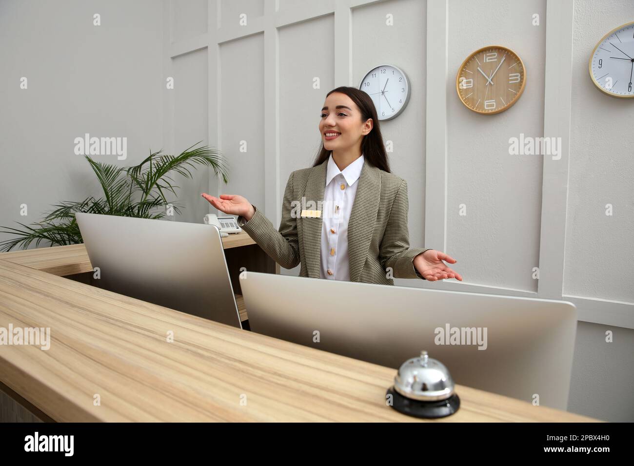 Beautiful receptionist working at counter in hotel Stock Photo - Alamy