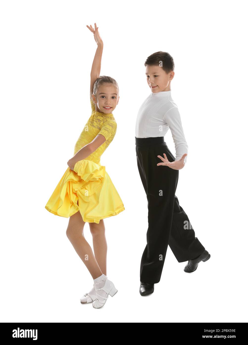 Beautifully dressed couple of kids dancing on white background Stock ...