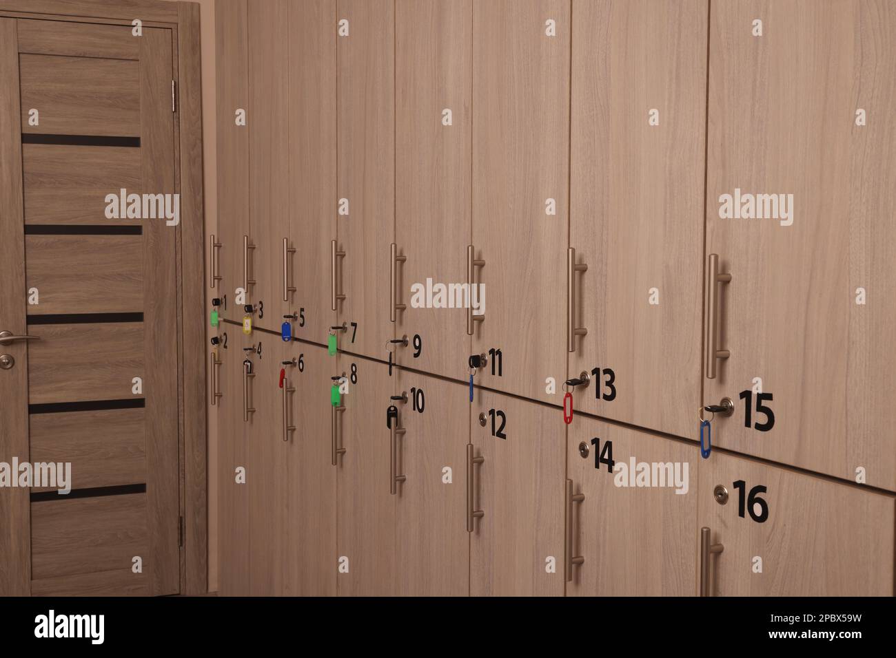 Many numbered wooden lockers with keys indoors Stock Photo - Alamy