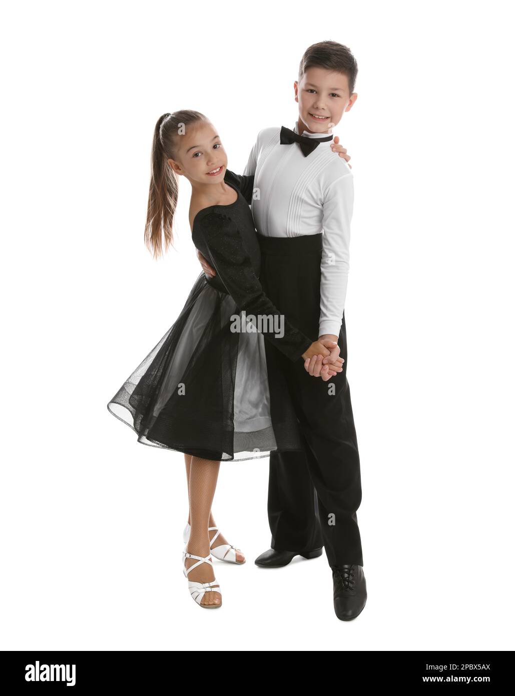 Beautifully dressed couple of kids dancing on white background Stock ...