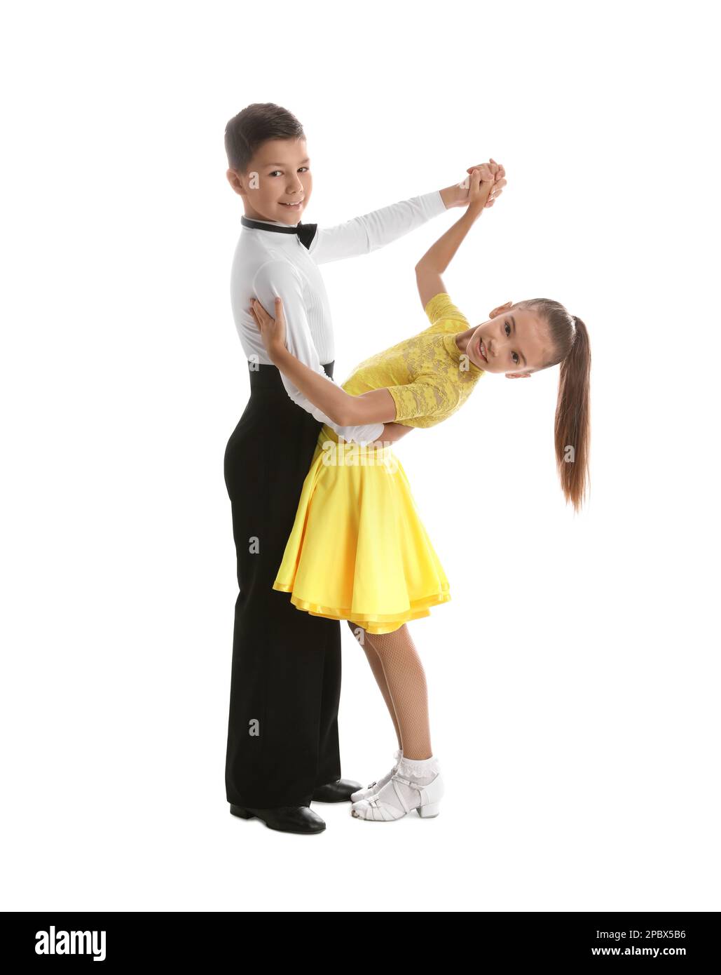 Beautifully dressed couple of kids dancing on white background Stock ...